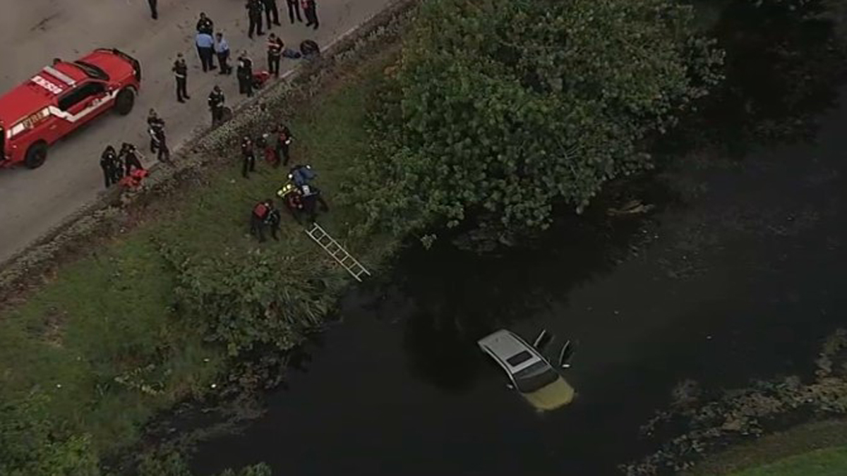 Driver hospitalized after being rescued from car that ended up ... Driver hospitalized after being rescued from car that ended up ...