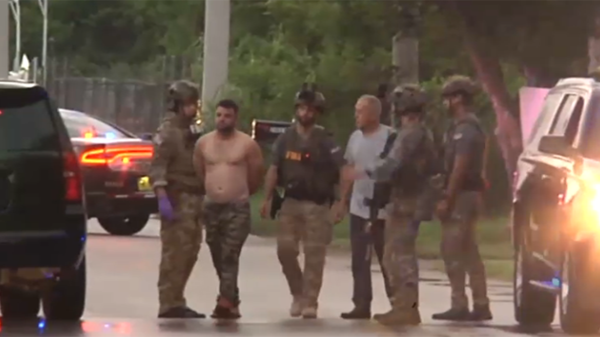 Man in custody after FBI leads raid at home next to school in southwest ...